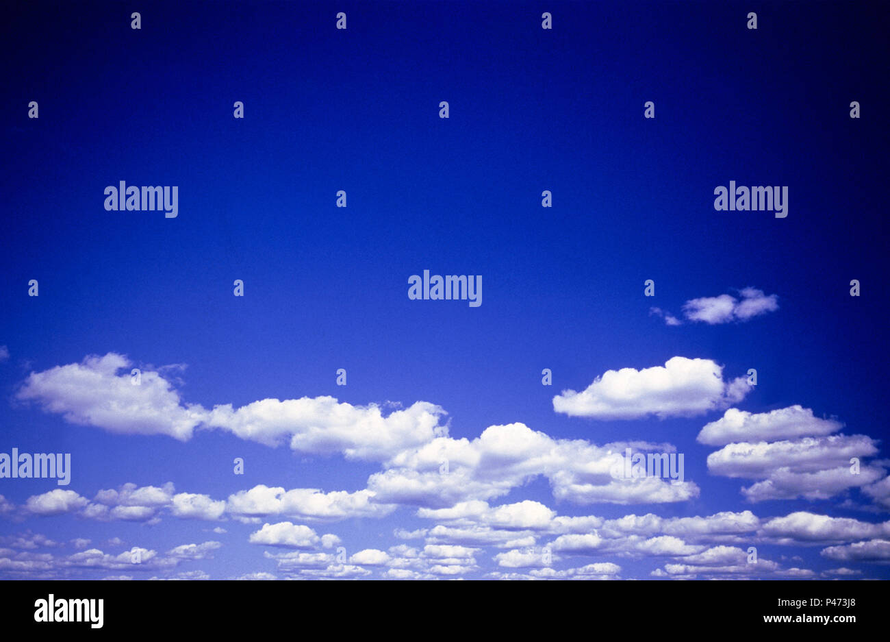Blue sky with fluffy white clouds Stock Photo - Alamy