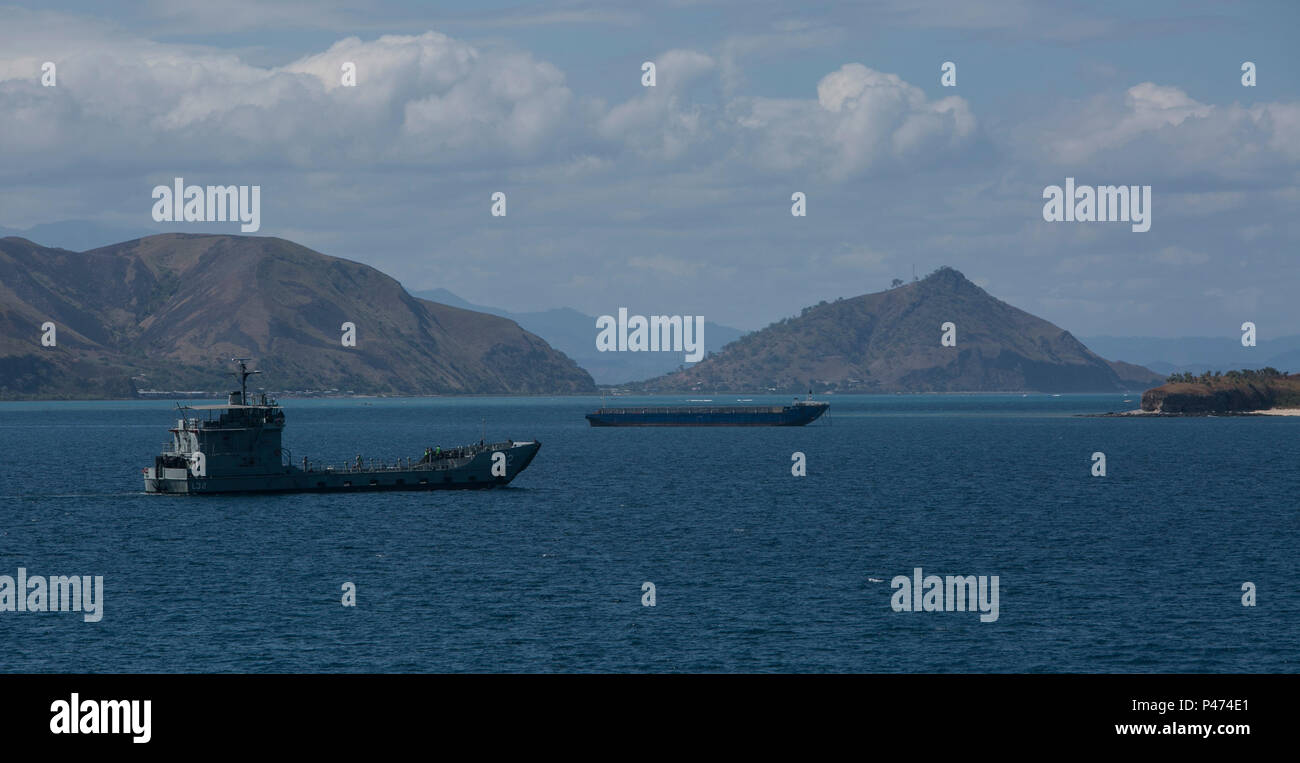 A Papua New Guinean naval ship heads toward USNS Sacagawea (T-AKE 2 ...