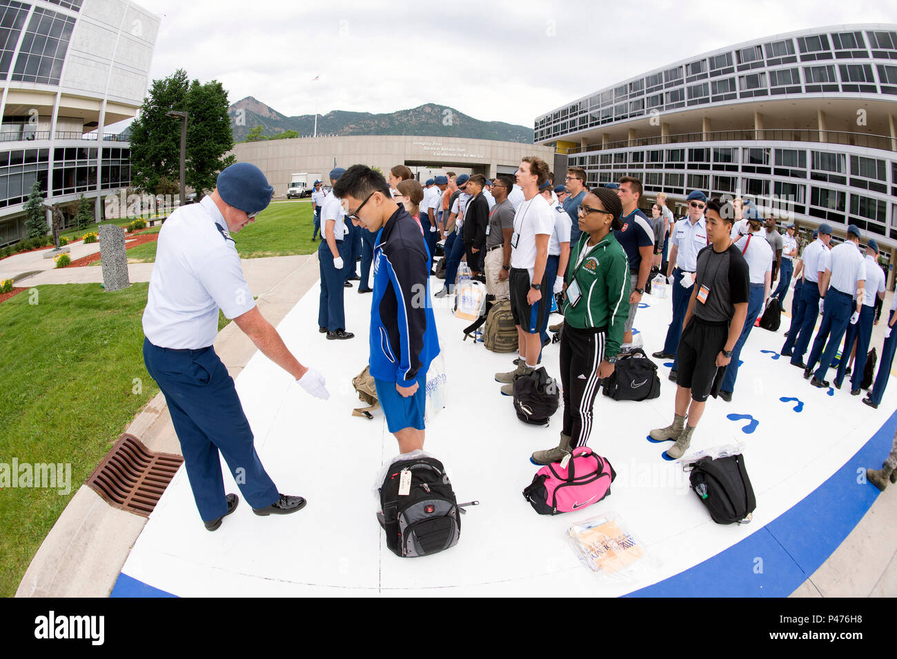 A Basic Cadet Training cadre member makes corrections on Inprocessing ...