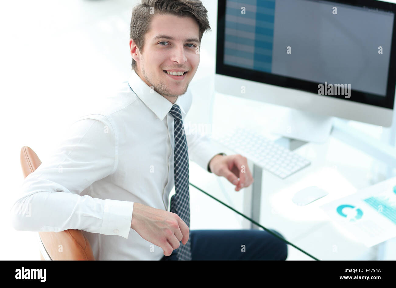 employee sitting in front of a computer screen Stock Photo - Alamy