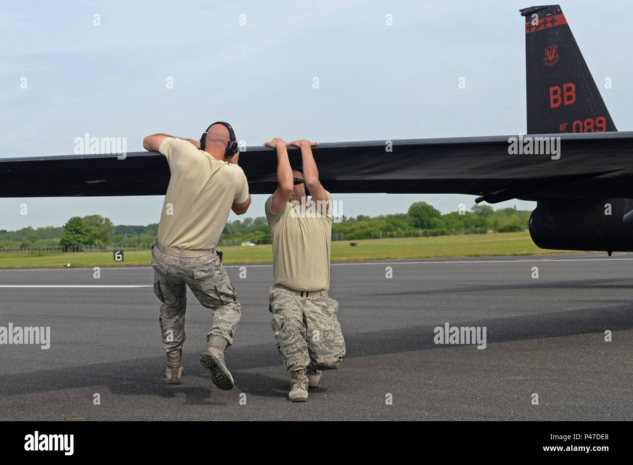9th Aircraft Maintenance Squadron Airmen pull down a U-2 Dragon Lady's wing to level the ...