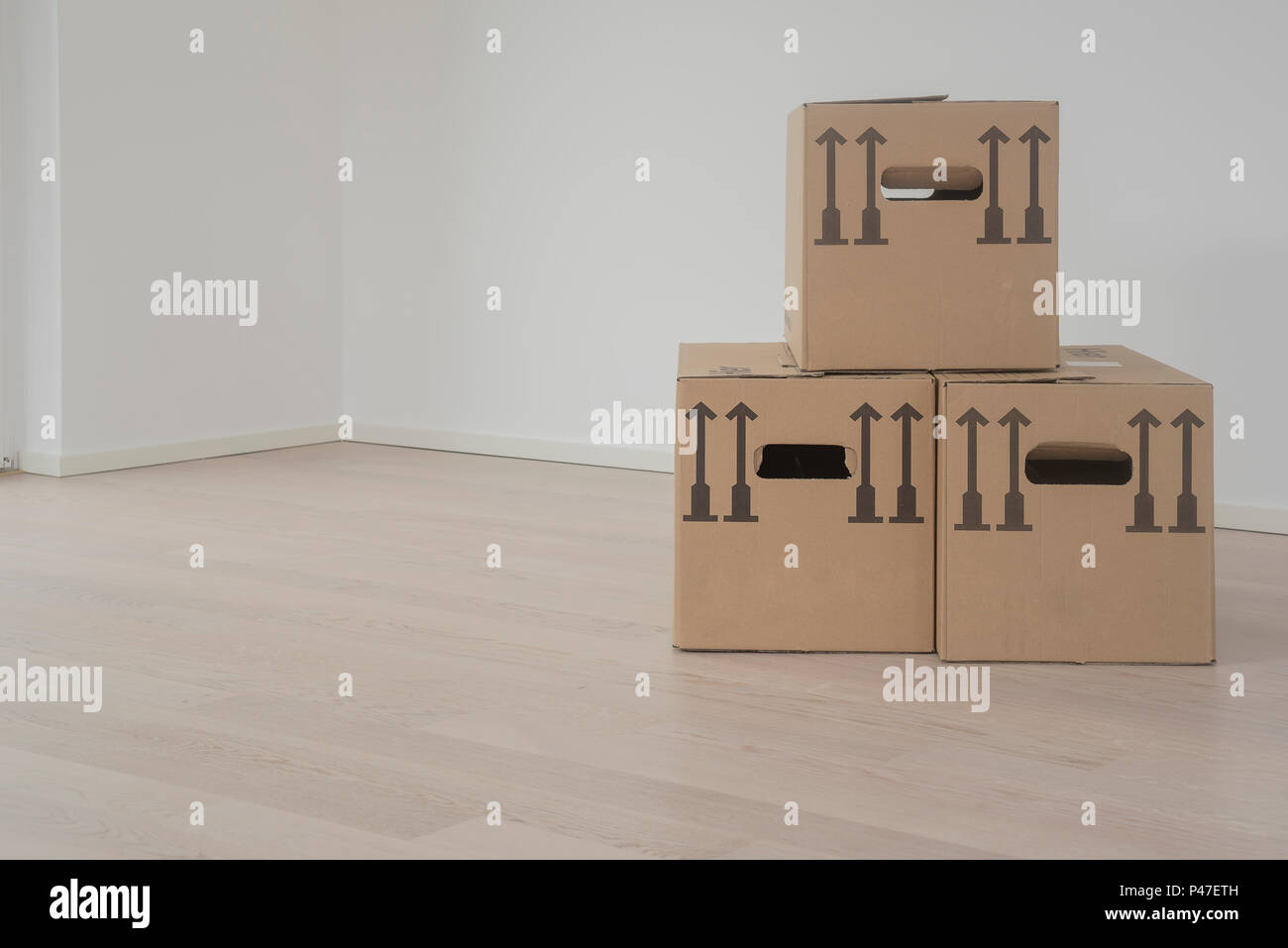 Moving card boxes in empty apartment Stock Photo - Alamy