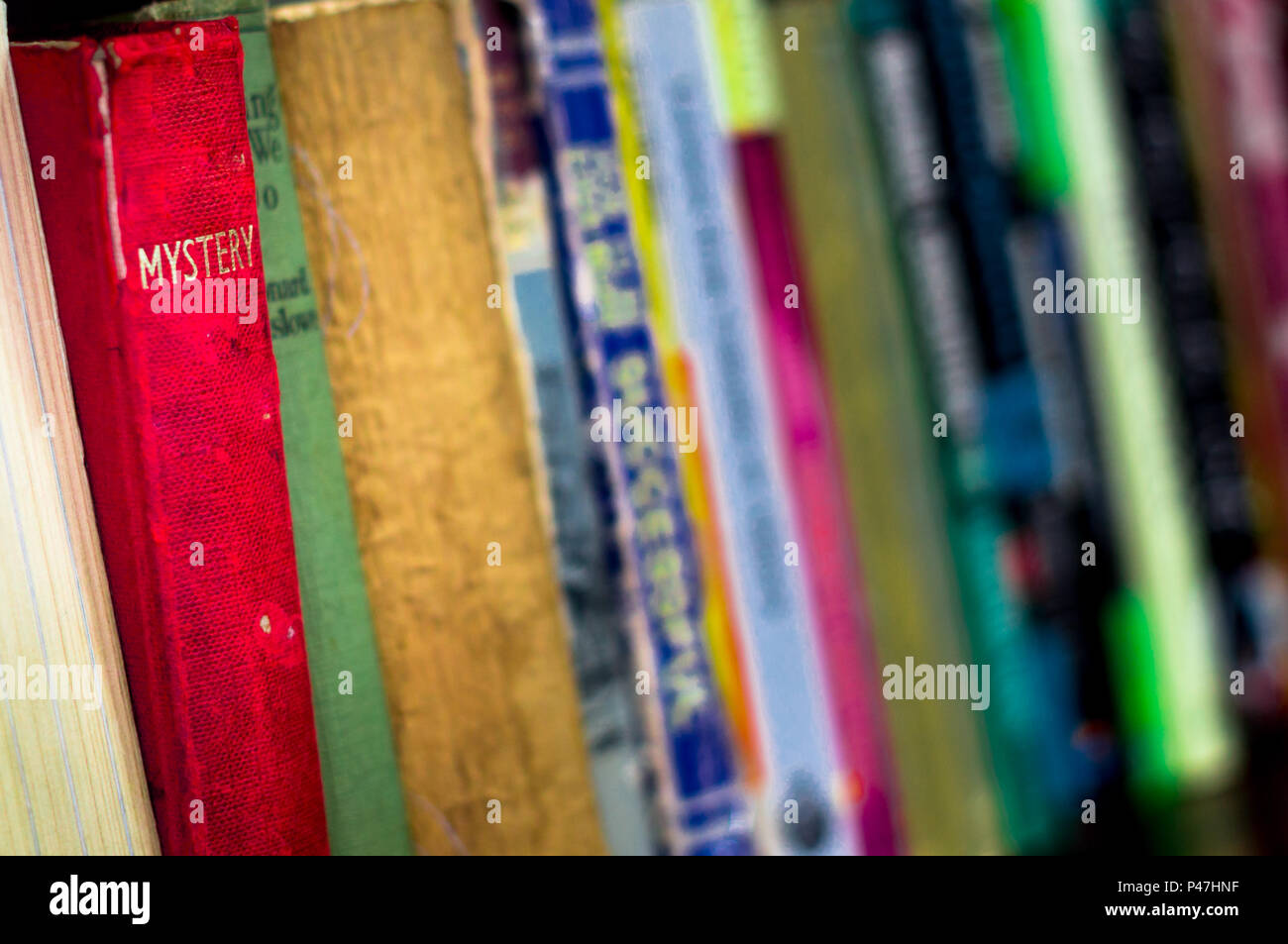 Colorful old books on a bookshelf Stock Photo - Alamy