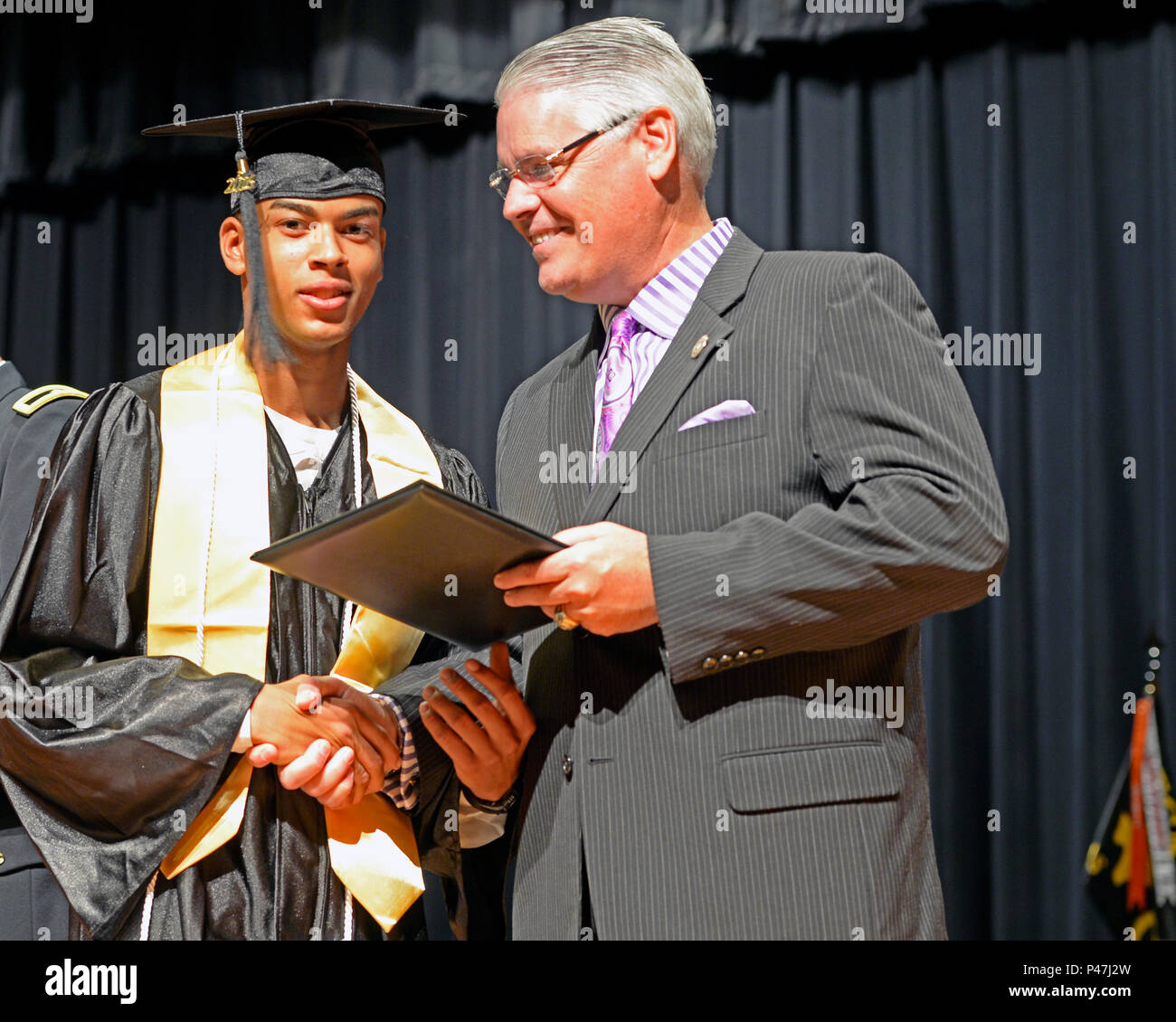 State Rep. Dan Huberty presents a cadet with his diploma cover during ...