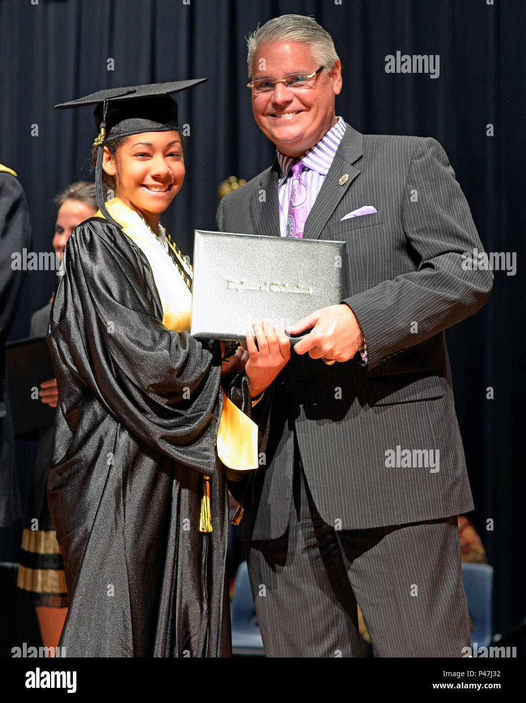 State Rep. Dan Huberty presents a cadet with his diploma cover during ...