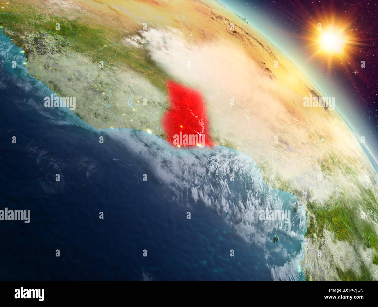 Sunrise above Ghana highlighted in red on model of planet Earth in ...