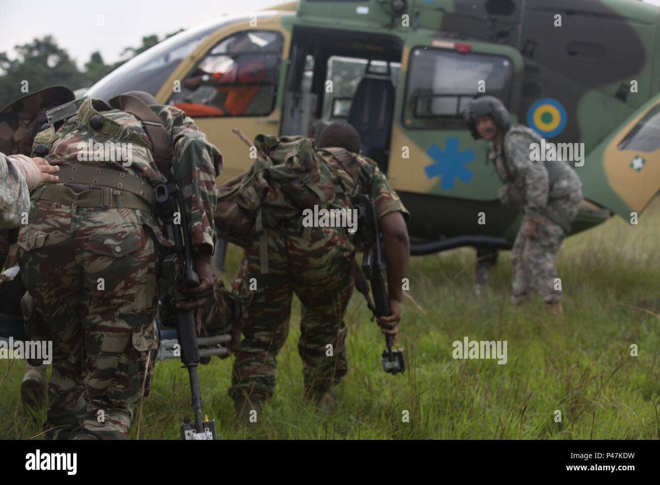 Cameroon soldiers carry a wounded Cameroon soldier to a MEDEVAC ...