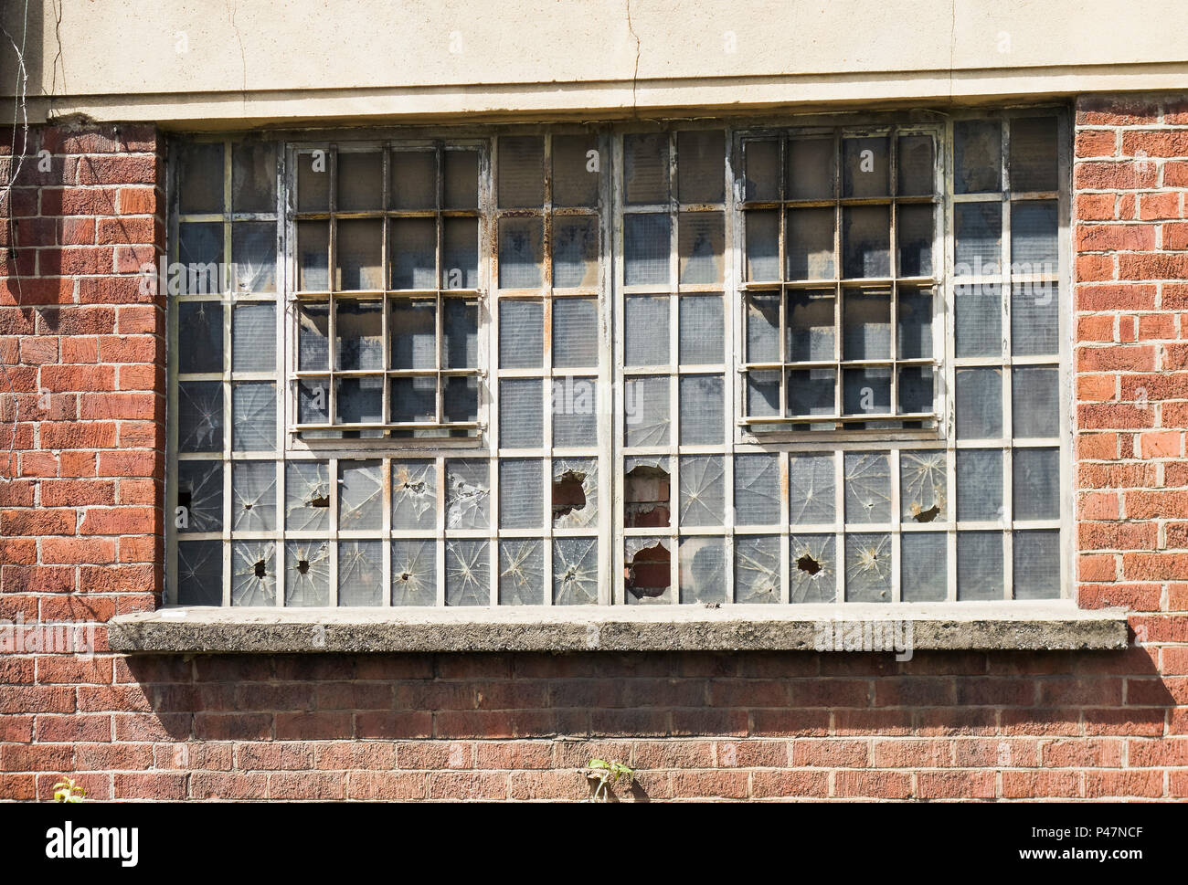 Broken windows on old derelict building Stock Photo - Alamy