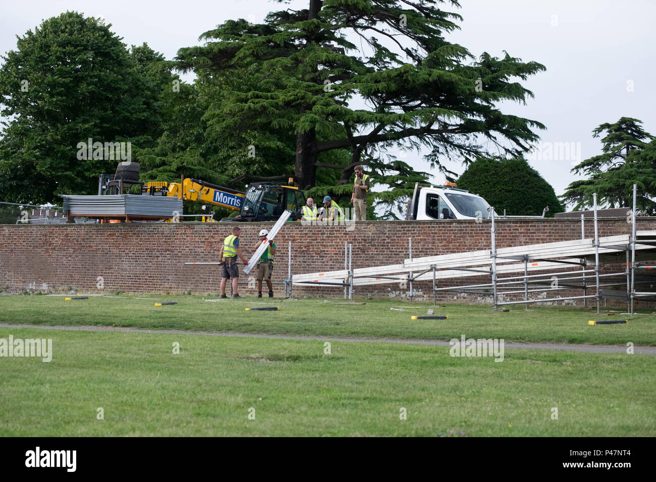 work men scaffolding building red brick Stock Photo - Alamy