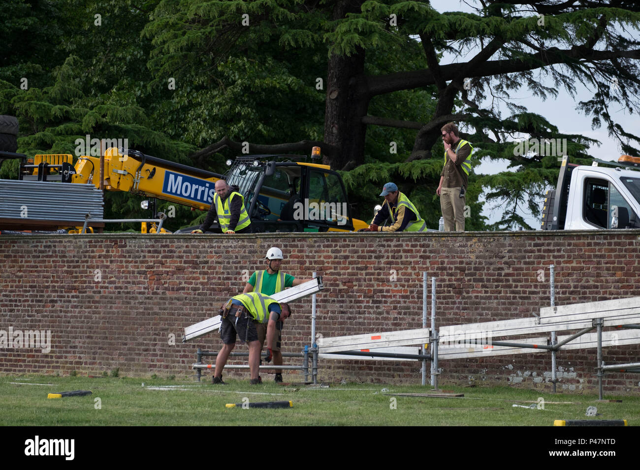 work men scaffolding building red brick Stock Photo - Alamy