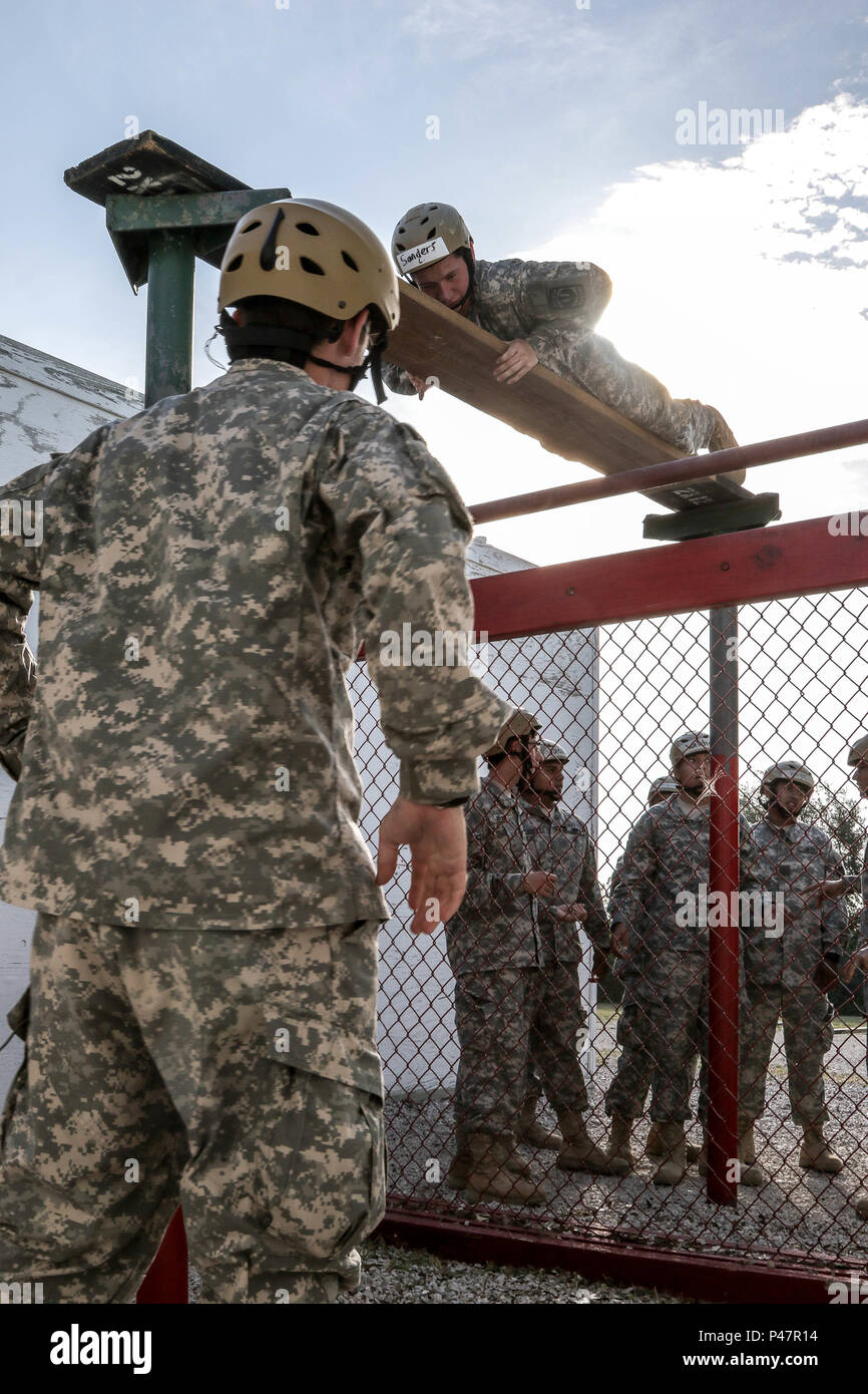 A platoon of cadets effectively crosses an overhead obstacle during the ...