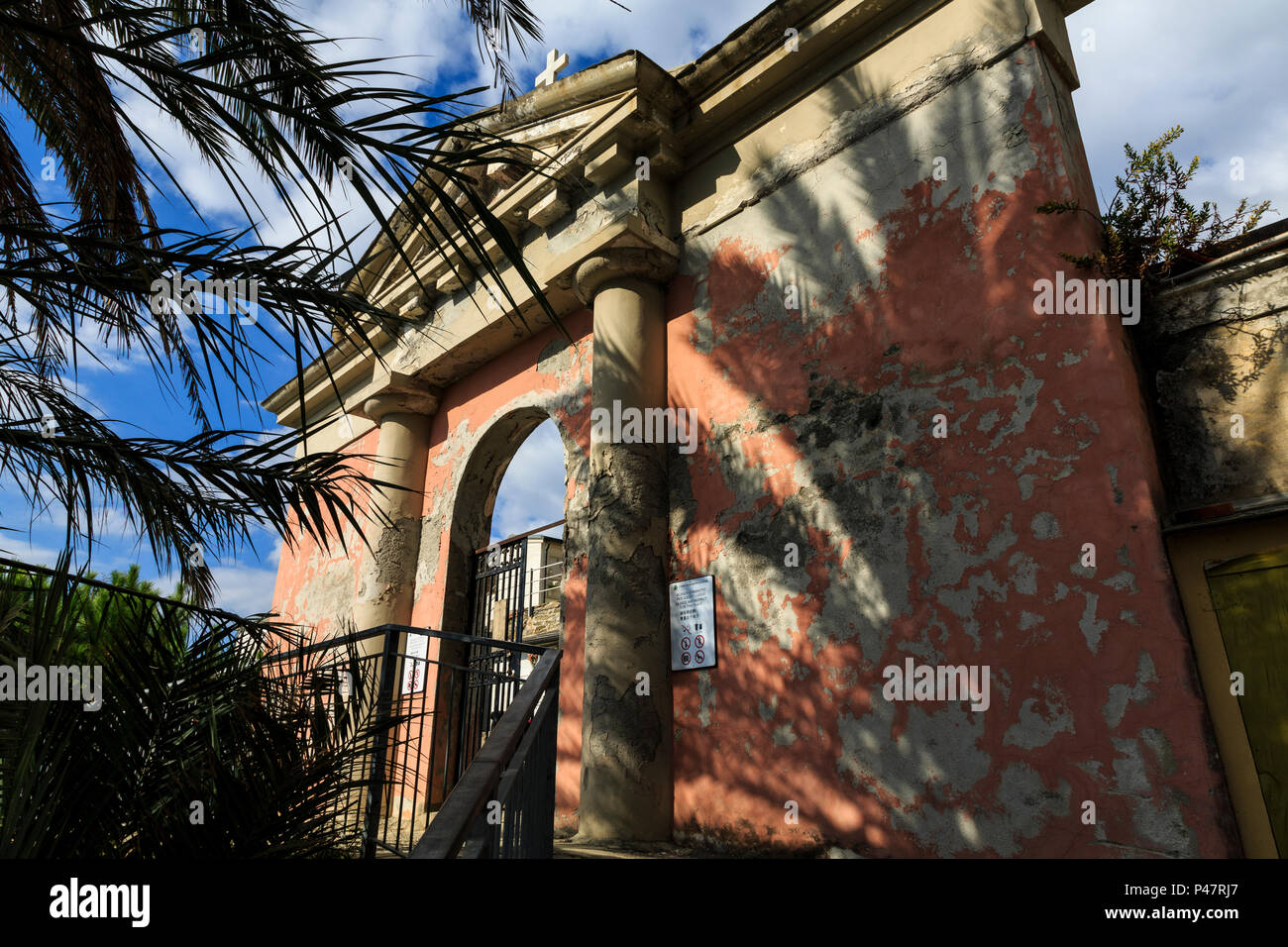 The faded, shaded old stone entrance gate to the historic cemetery in ...