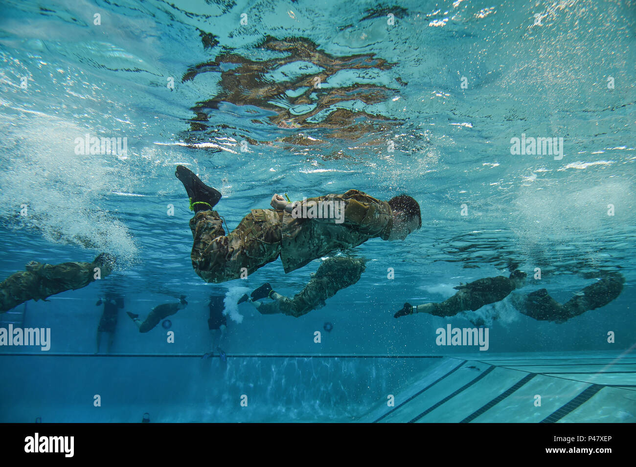 Special Tactics Training Squadron students swim the length of the pool ...