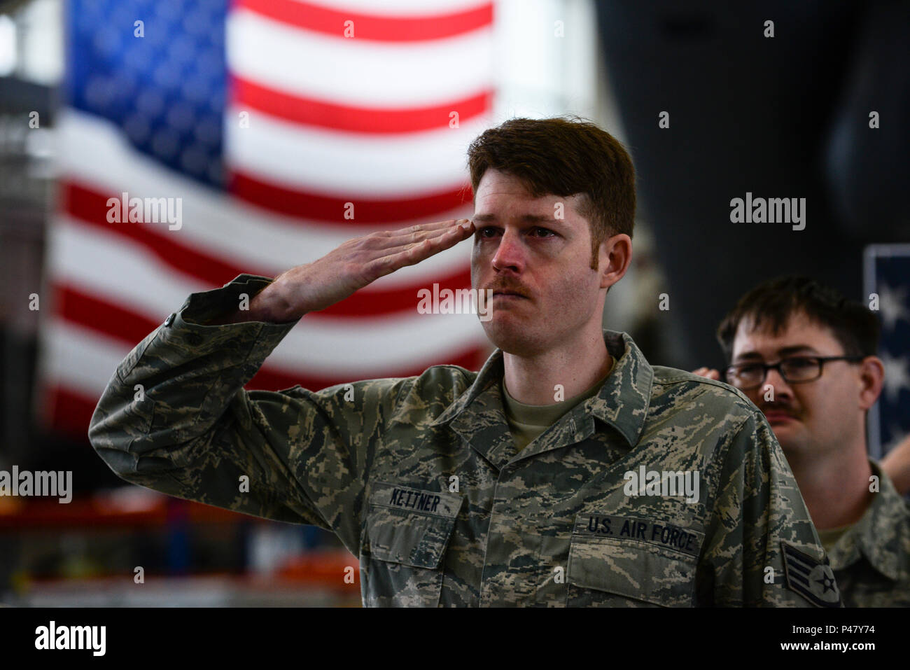 Military members salute during a memorial service for U.S. Air Force ...