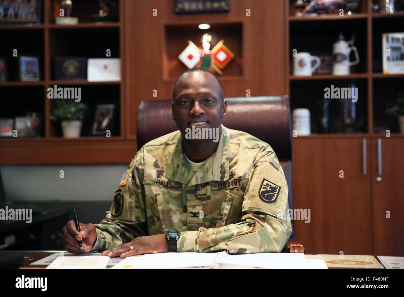 U.S. Army Col. Jimmy L. Hall Jr., commander of 5th Signal Command (Theater), works at his desk ...