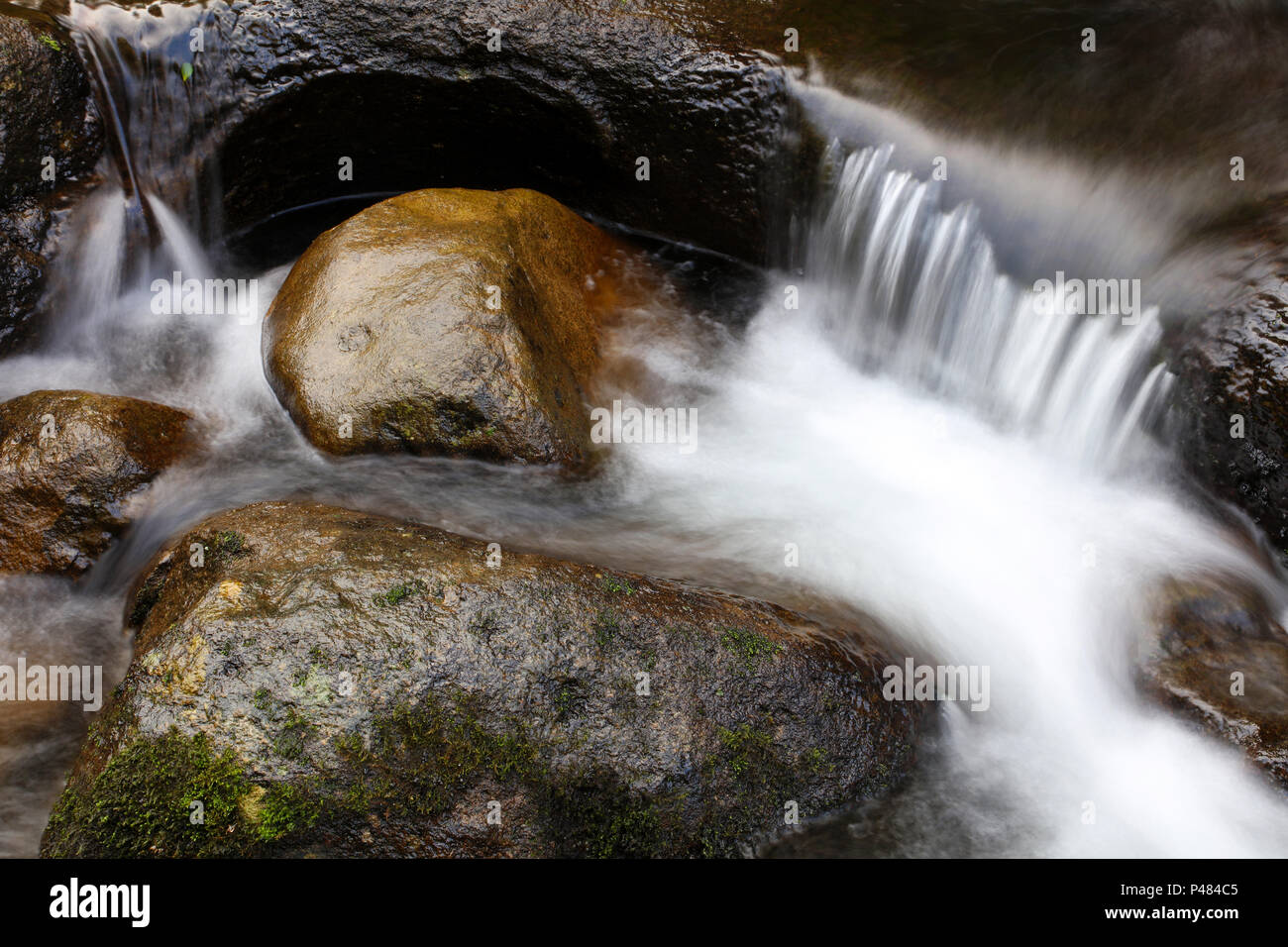 Water flowing over rocks in stream Stock Photo - Alamy