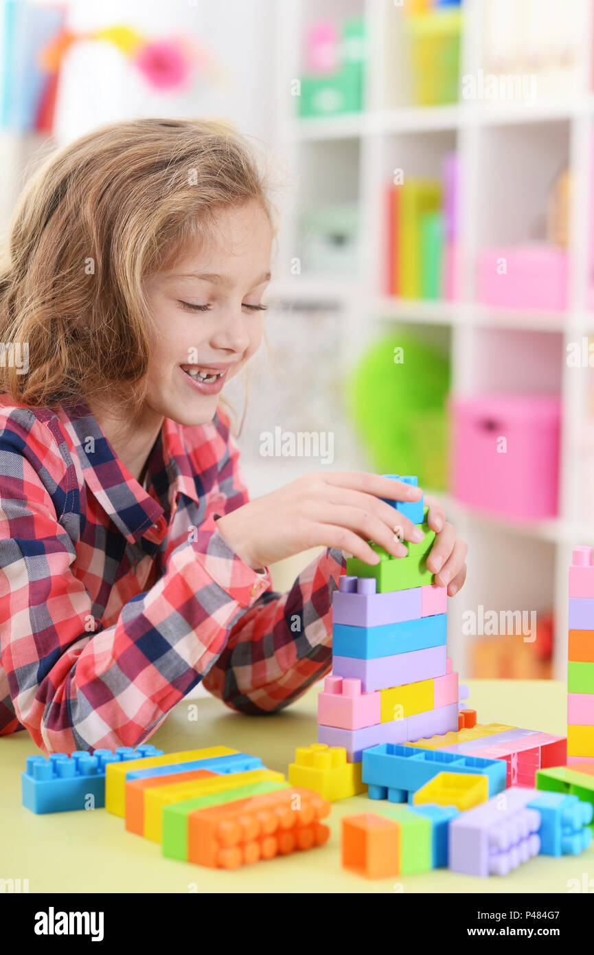 little girl playing with colorful plastic blocks Stock Photo - Alamy