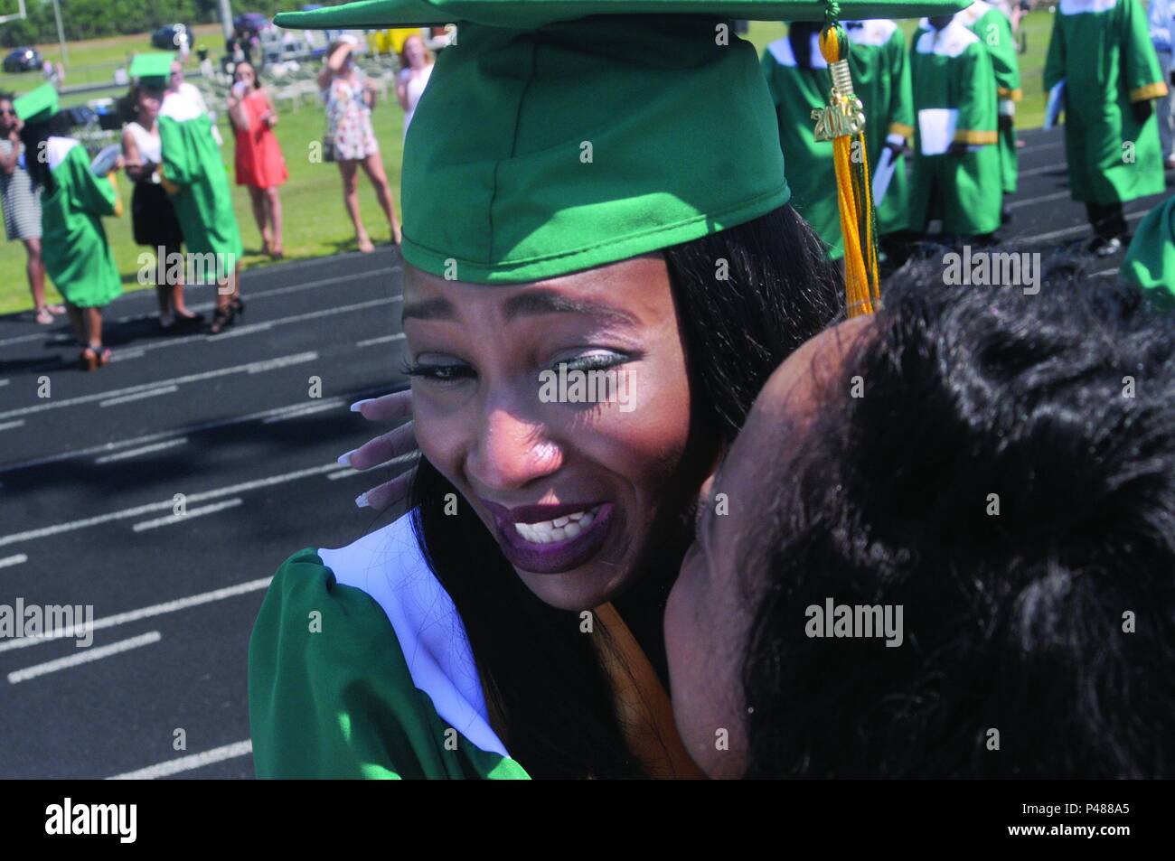 Markeisha L.B. Young embrances a friend after the commencement ...
