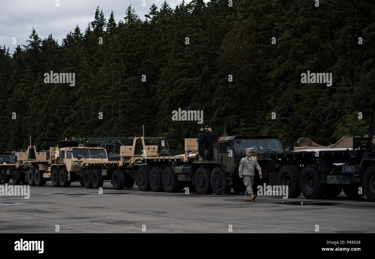 A U.S. Army soldier prepares for cargo containers to be loaded onto U.S ...