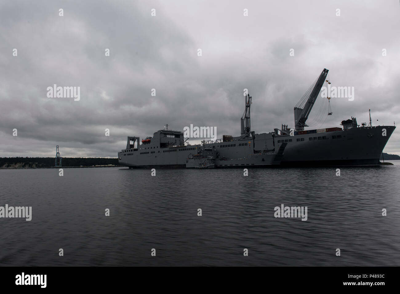 U.S. Navy and U.S. Army vessels unload cargo containers during Joint ...