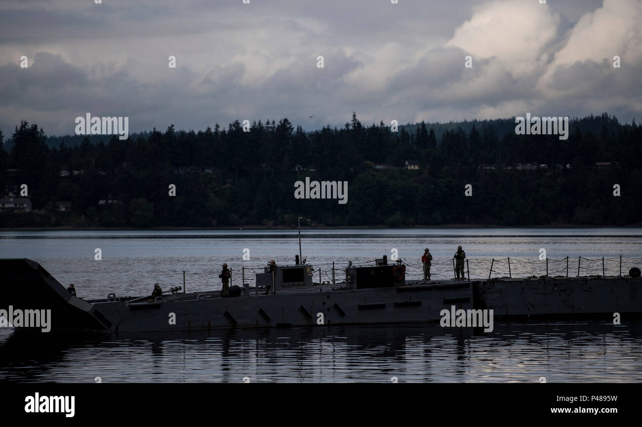 A U.S. Navy Improved Navy Lighterage System Causeway Ferry, prepares to ...