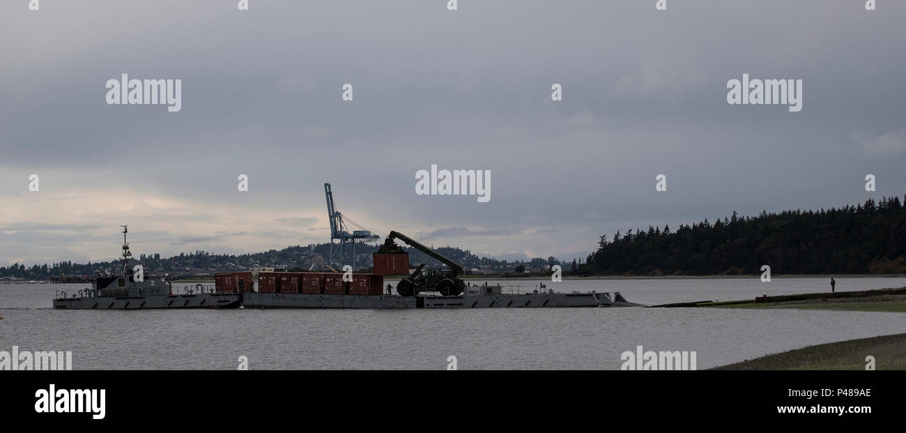 U.S. Navy sailors unload cargo containers from an Improved Navy ...