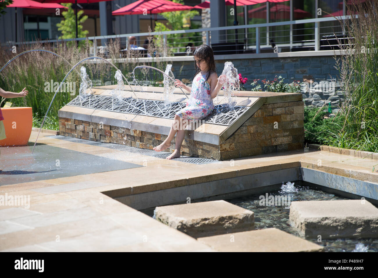 Philadelphia, Pennsylvania June 16 2018: Little girl playing water at ...