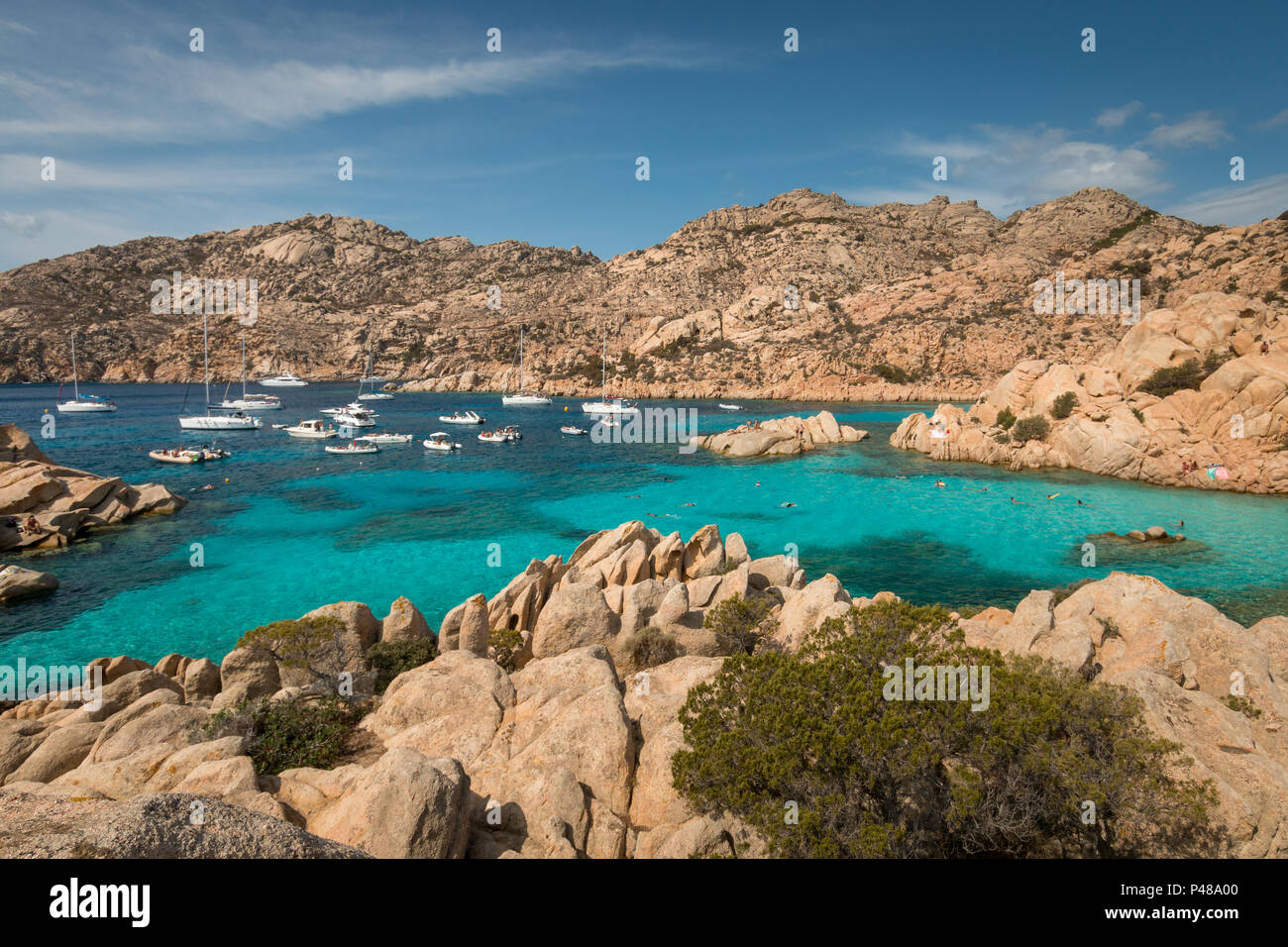 Many boats anchoring at beautiful Cala Coticcio on the Italian island ...