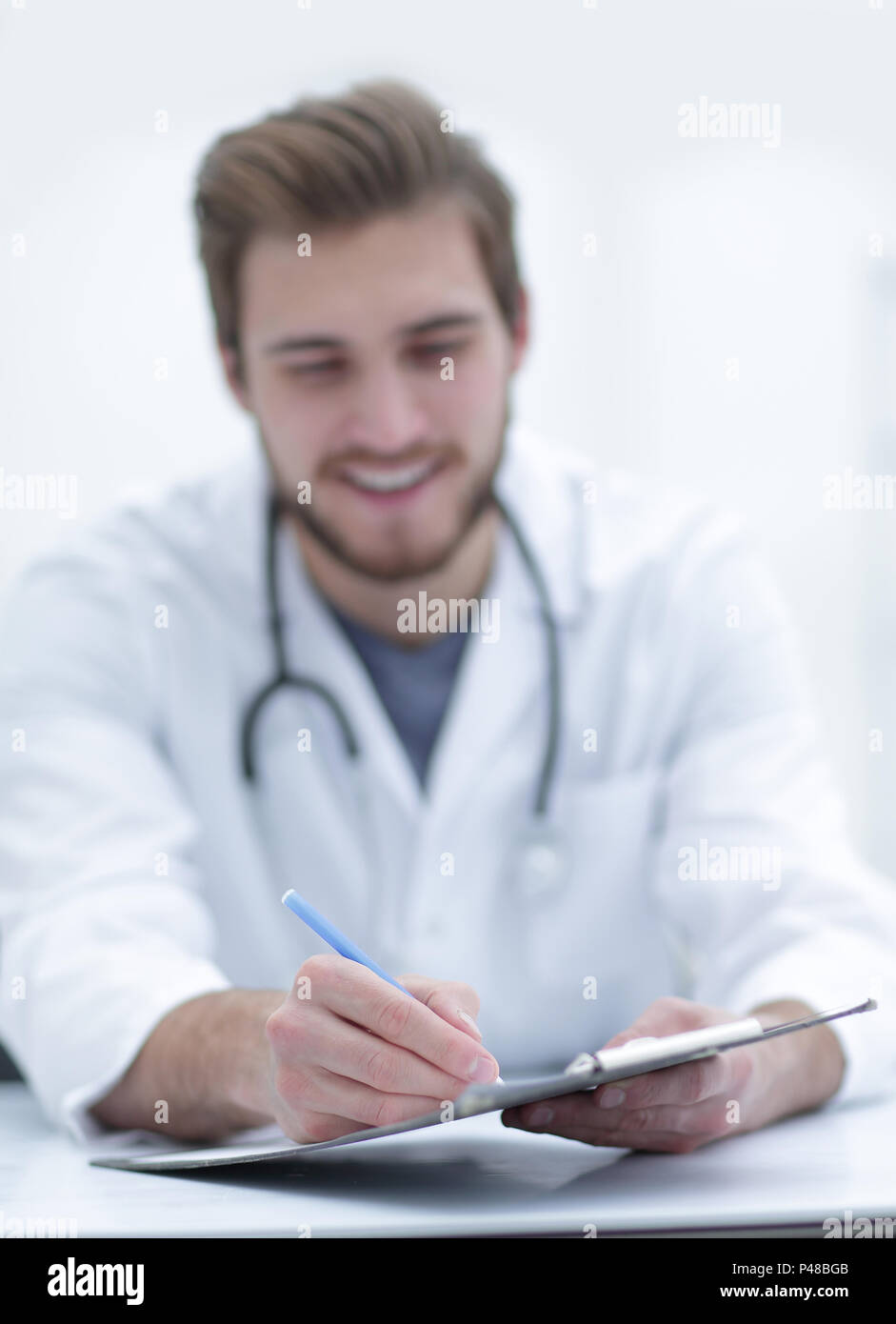 background image of a doctor writing out a prescription Stock Photo - Alamy