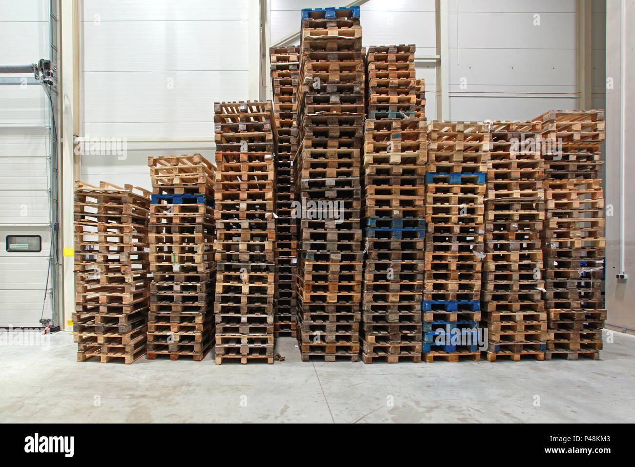 Used Wooden Cargo Pallets in Distribution Warehouse Stock Photo - Alamy