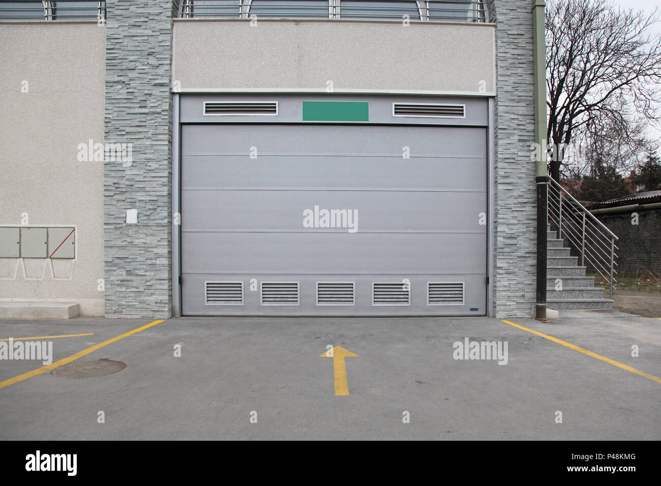 Closed Rrey Garage Door Entrance in Building Stock Photo - Alamy