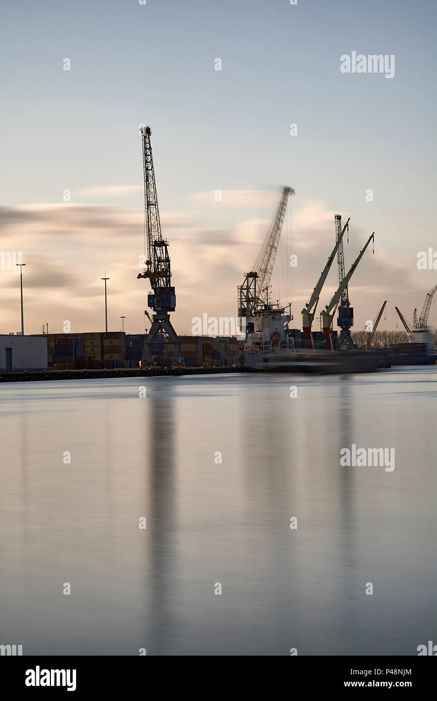 Cranes loading and unloading containerships in the international port ...
