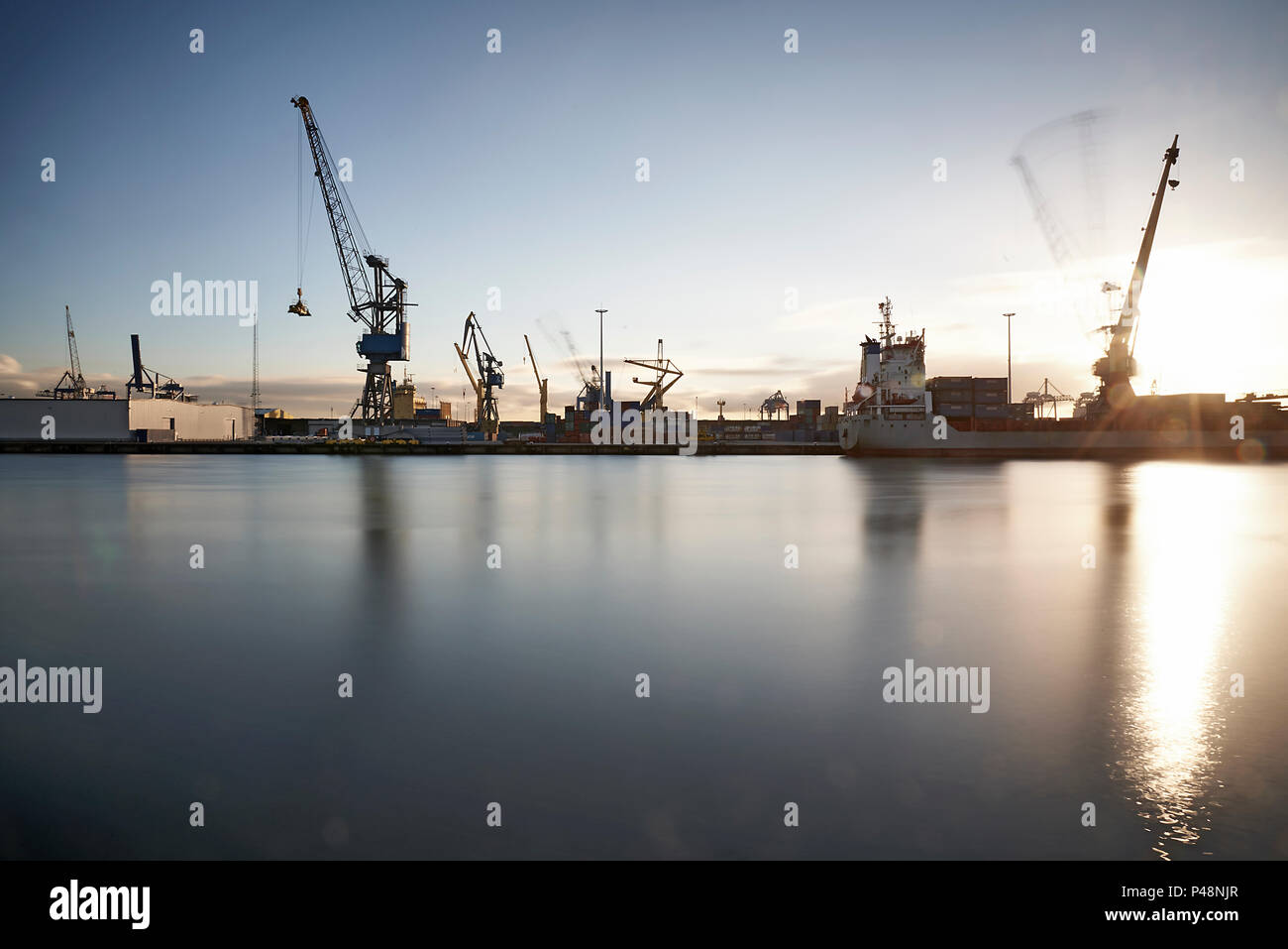 Cranes loading and unloading containerships in the international port ...
