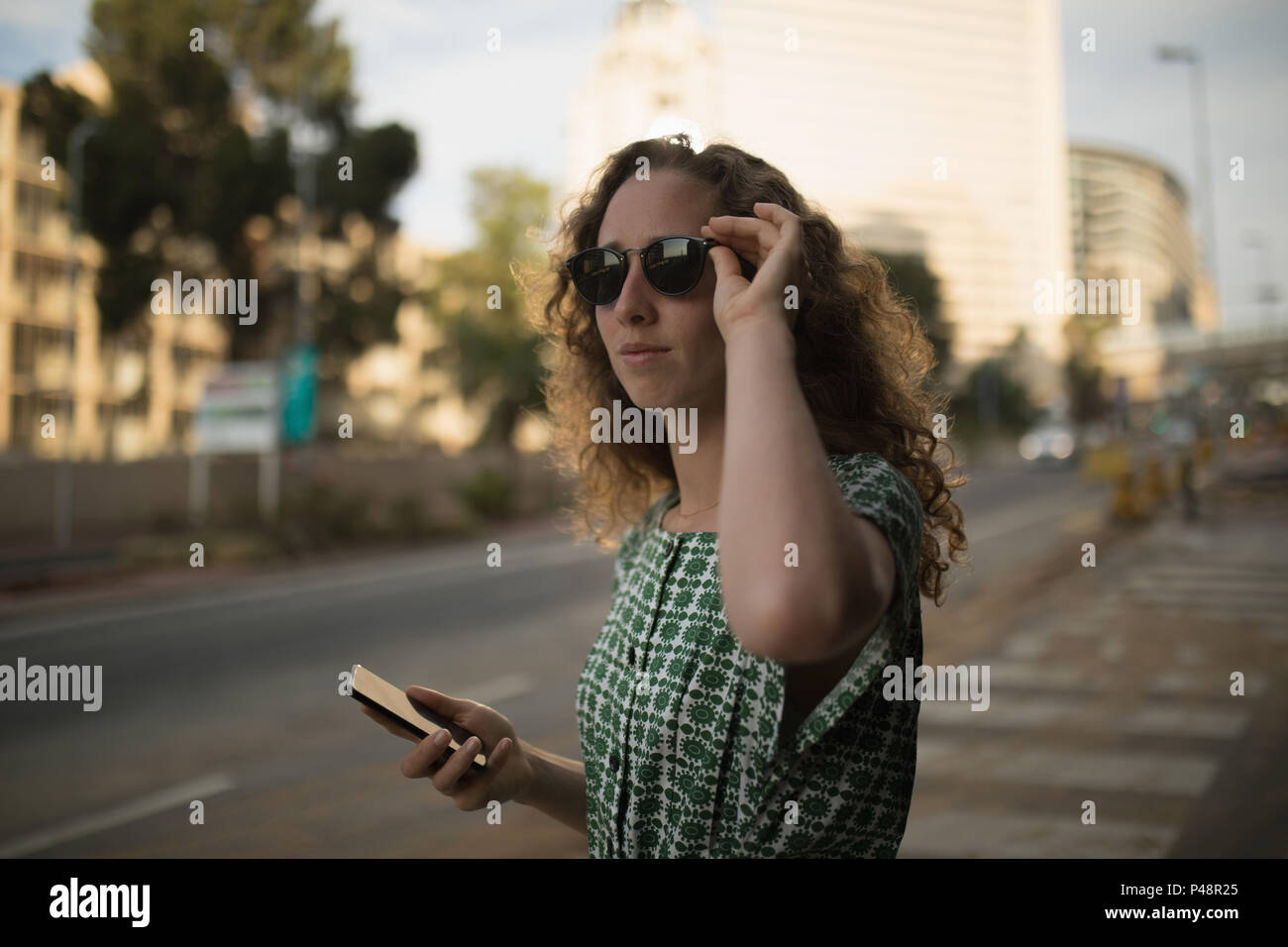 Young woman on city roadside hi-res stock photography and images - Alamy