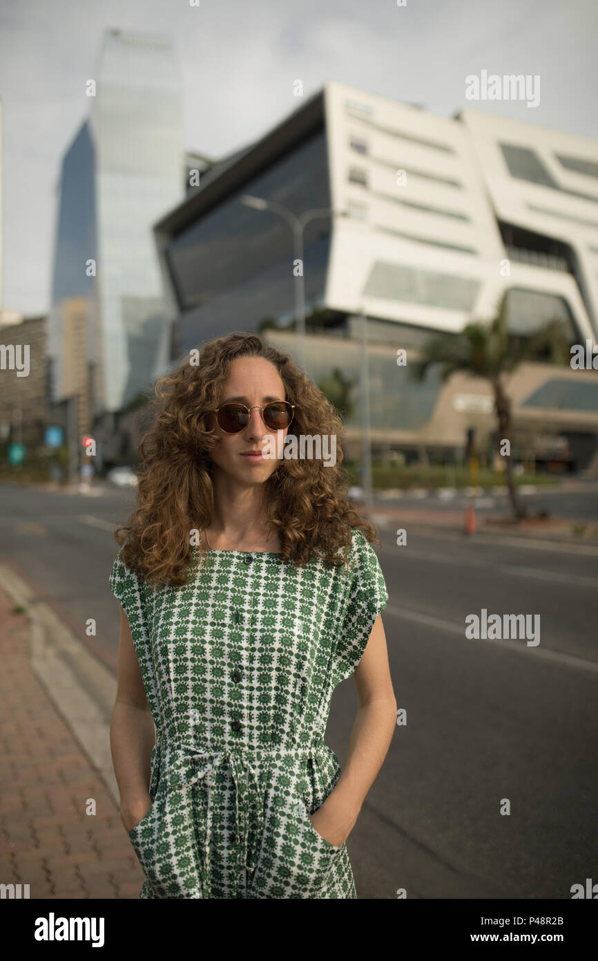 Young woman on city roadside hi-res stock photography and images - Alamy