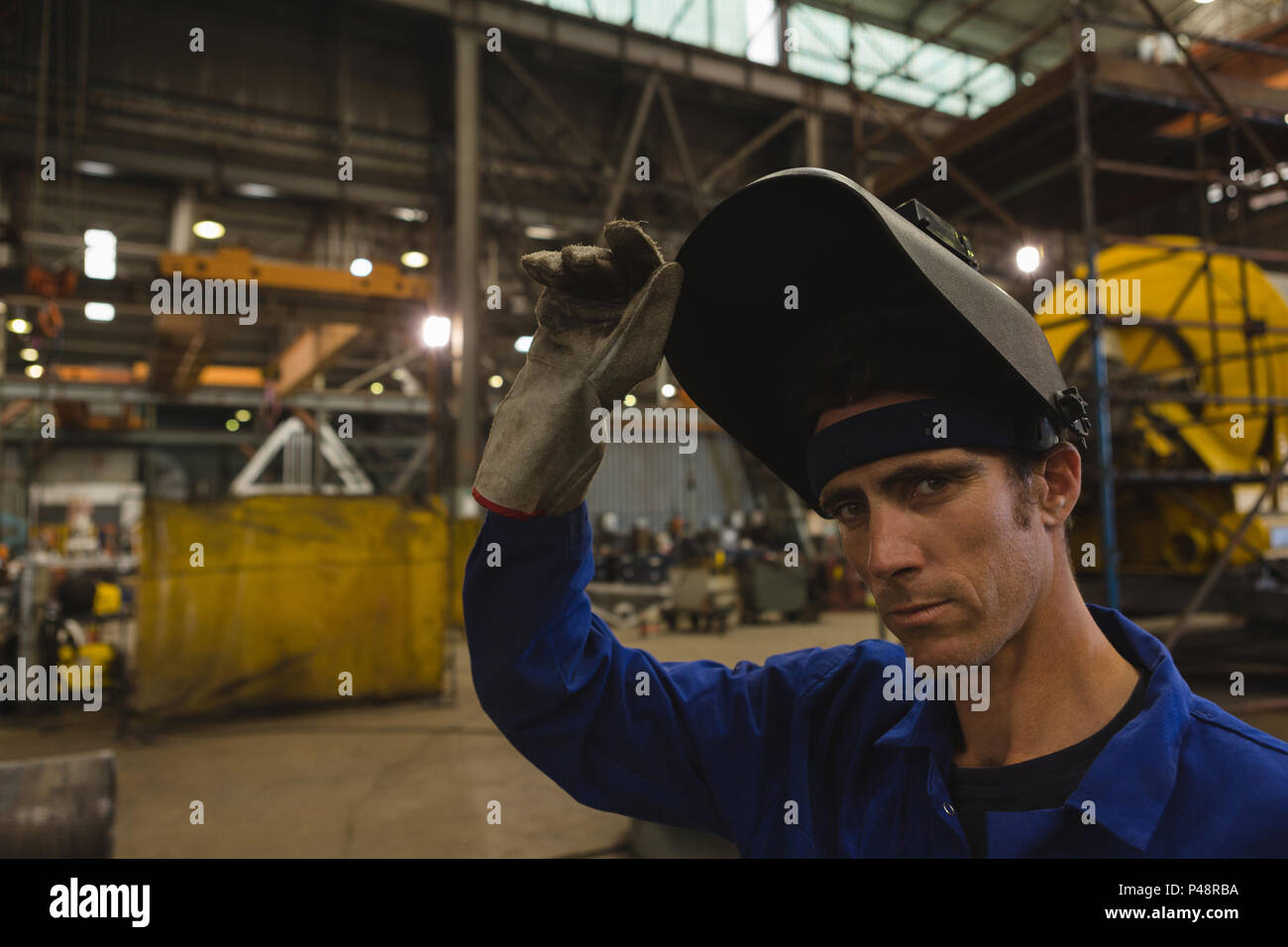 Portrait of confident welder holding welding helmet Stock Photo - Alamy