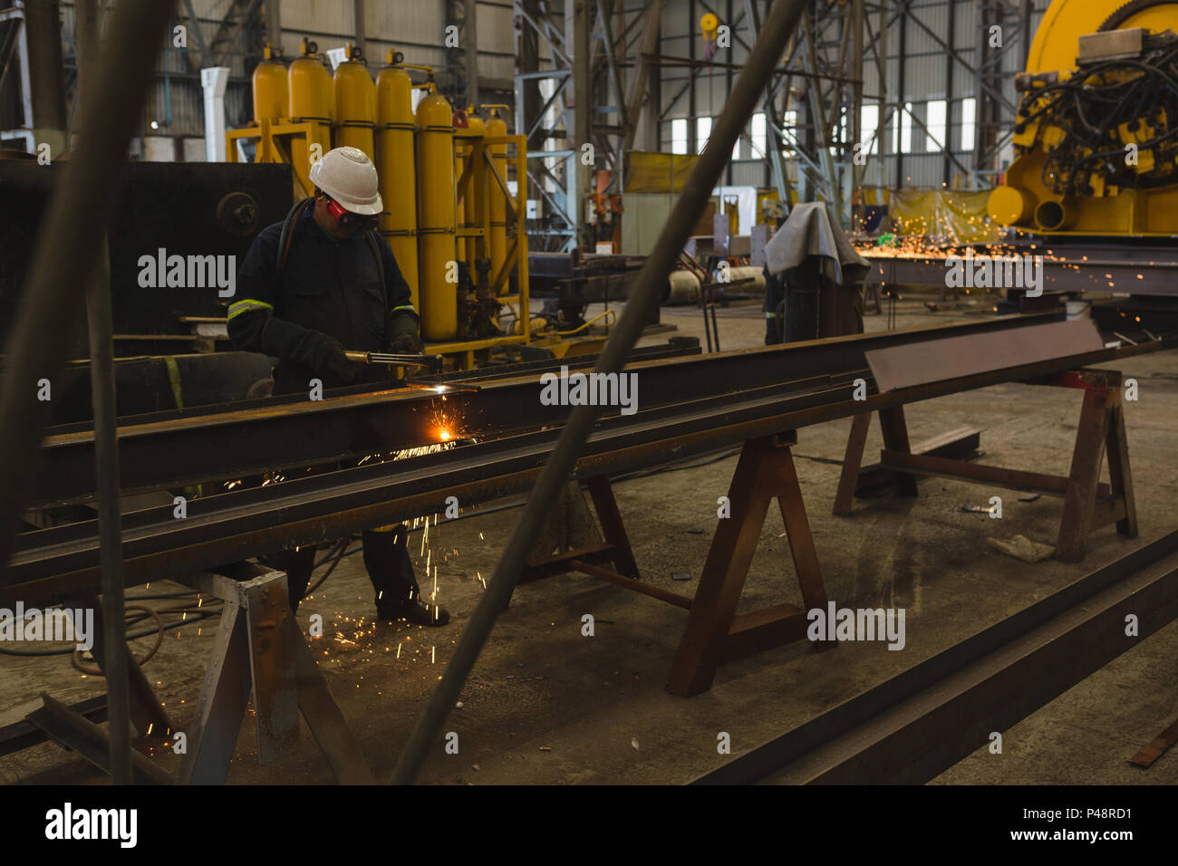 Welder repairing metal frame Stock Photo - Alamy