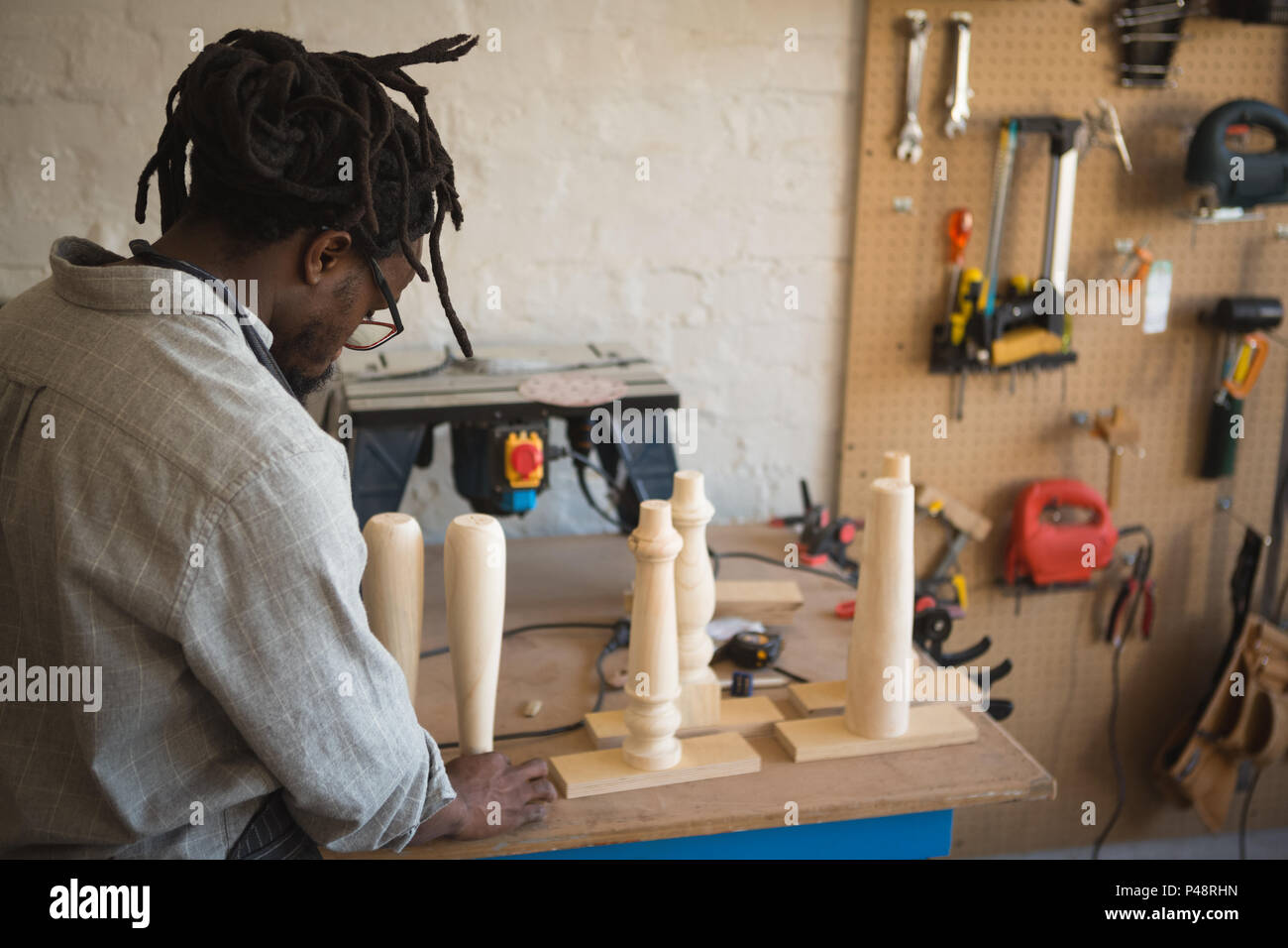 Carpenter preparing wooden column Stock Photo - Alamy