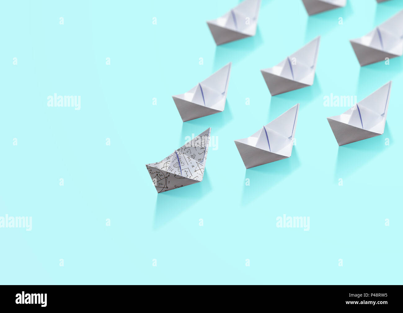paper boat ship, different leadership concept Stock Photo - Alamy