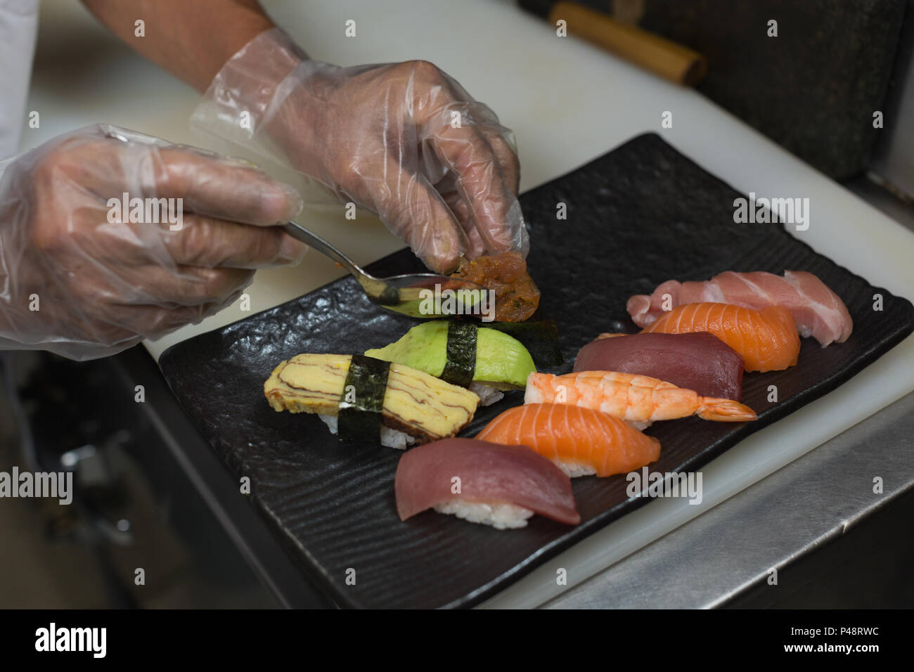Chef arranging sea food in a tray Stock Photo - Alamy
