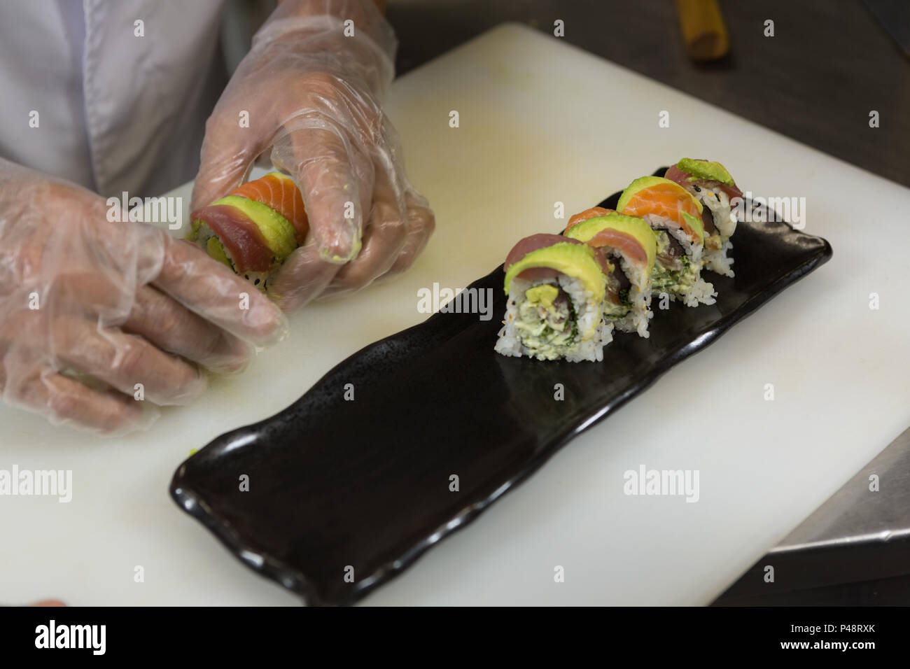 Senior chef preparing sushi in kitchen Stock Photo - Alamy