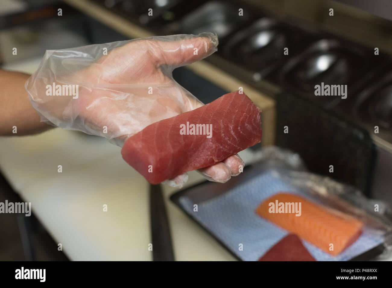 Chef holding sea food in kitchen Stock Photo - Alamy