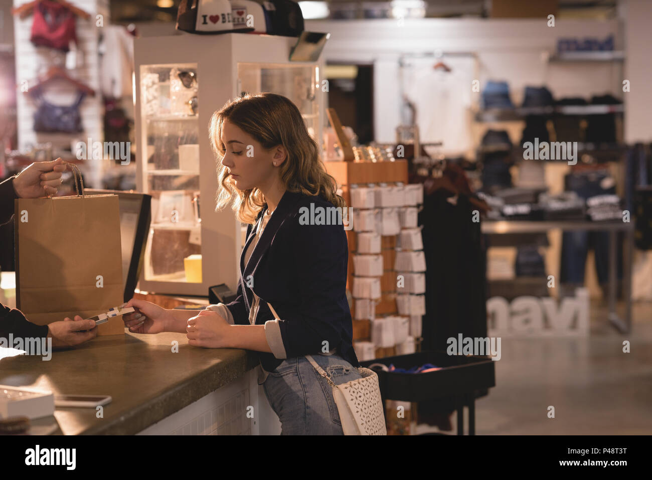 Woman making payment through card Stock Photo - Alamy