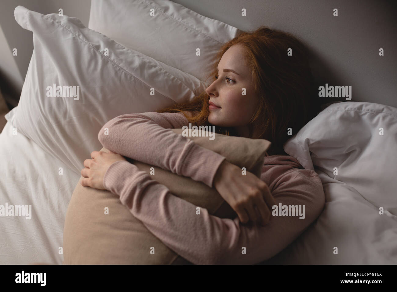 Beautiful redhead woman on bed hi-res stock photography and images - Alamy