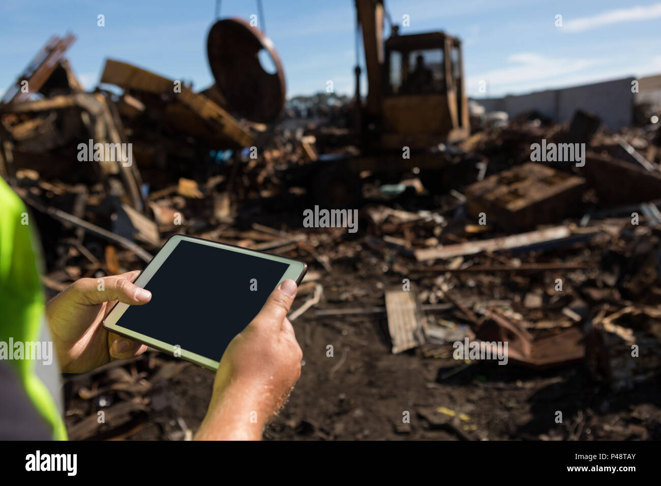 Worker holding digital tablet in the scrapyard Stock Photo - Alamy