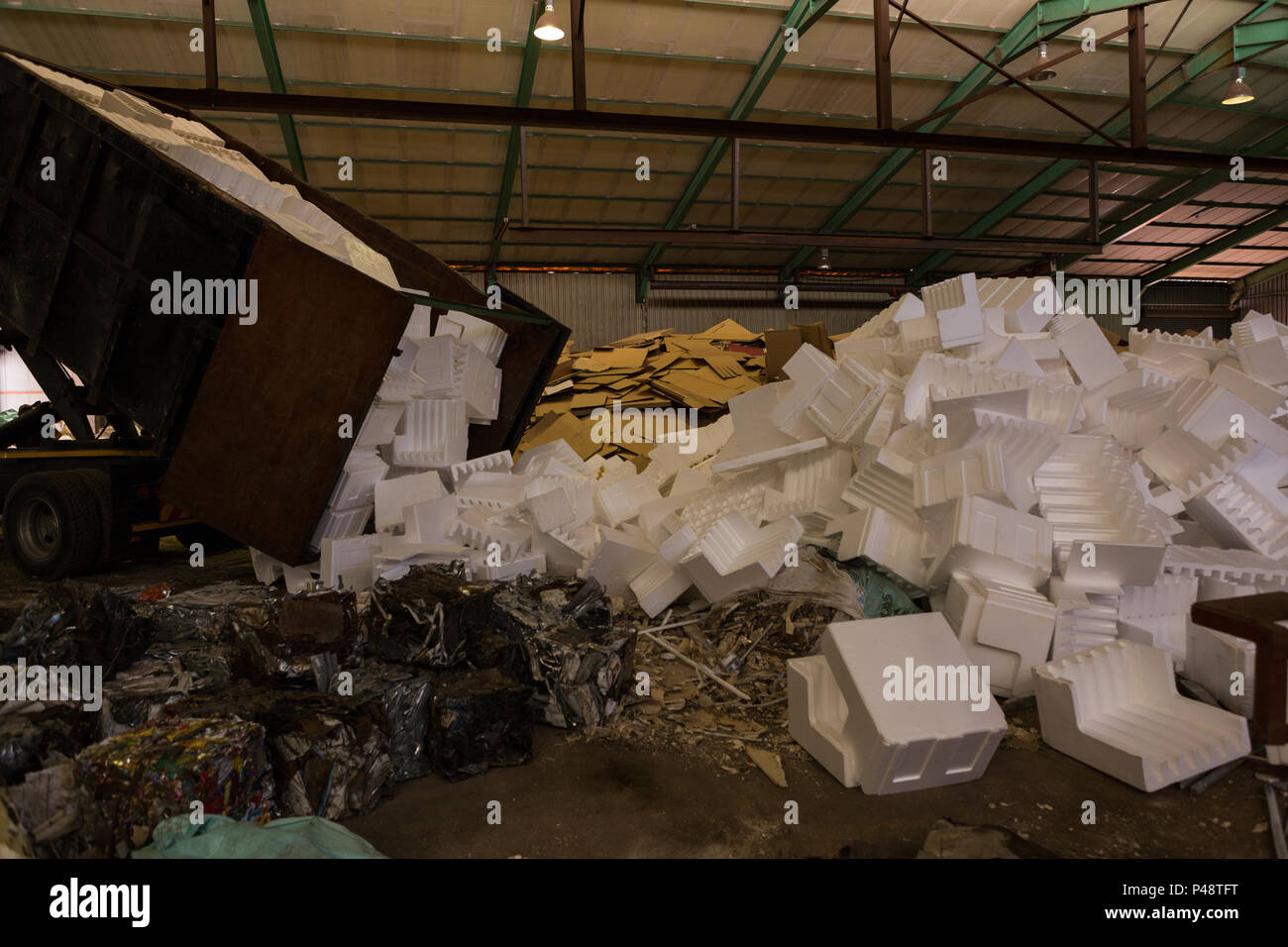 Truck emptying thermocol in the scrapyard Stock Photo - Alamy