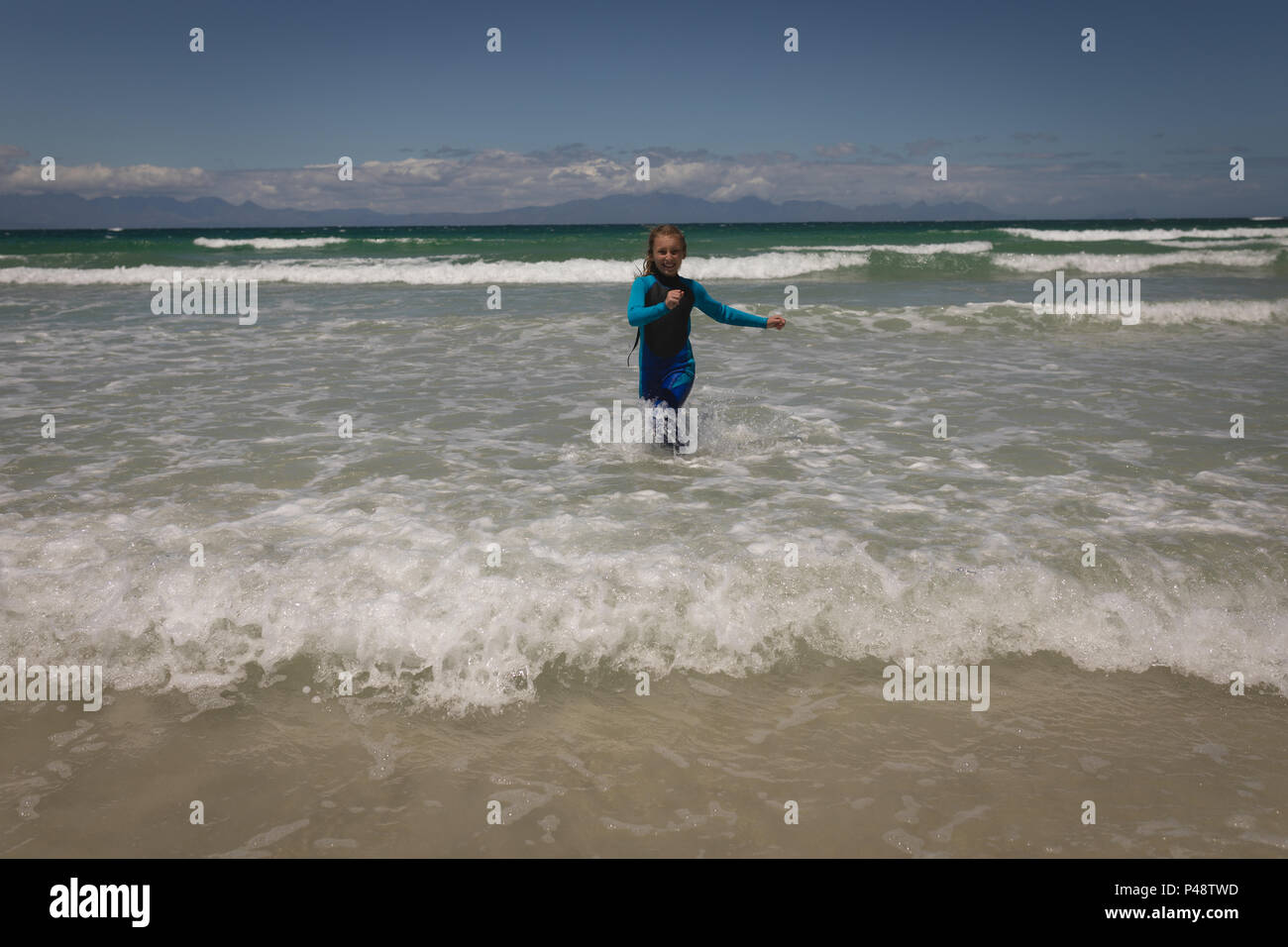 Happy girl running in sea Stock Photo - Alamy