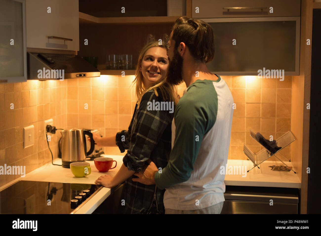 Couple romancing in kitchen hi-res stock photography and images - Alamy