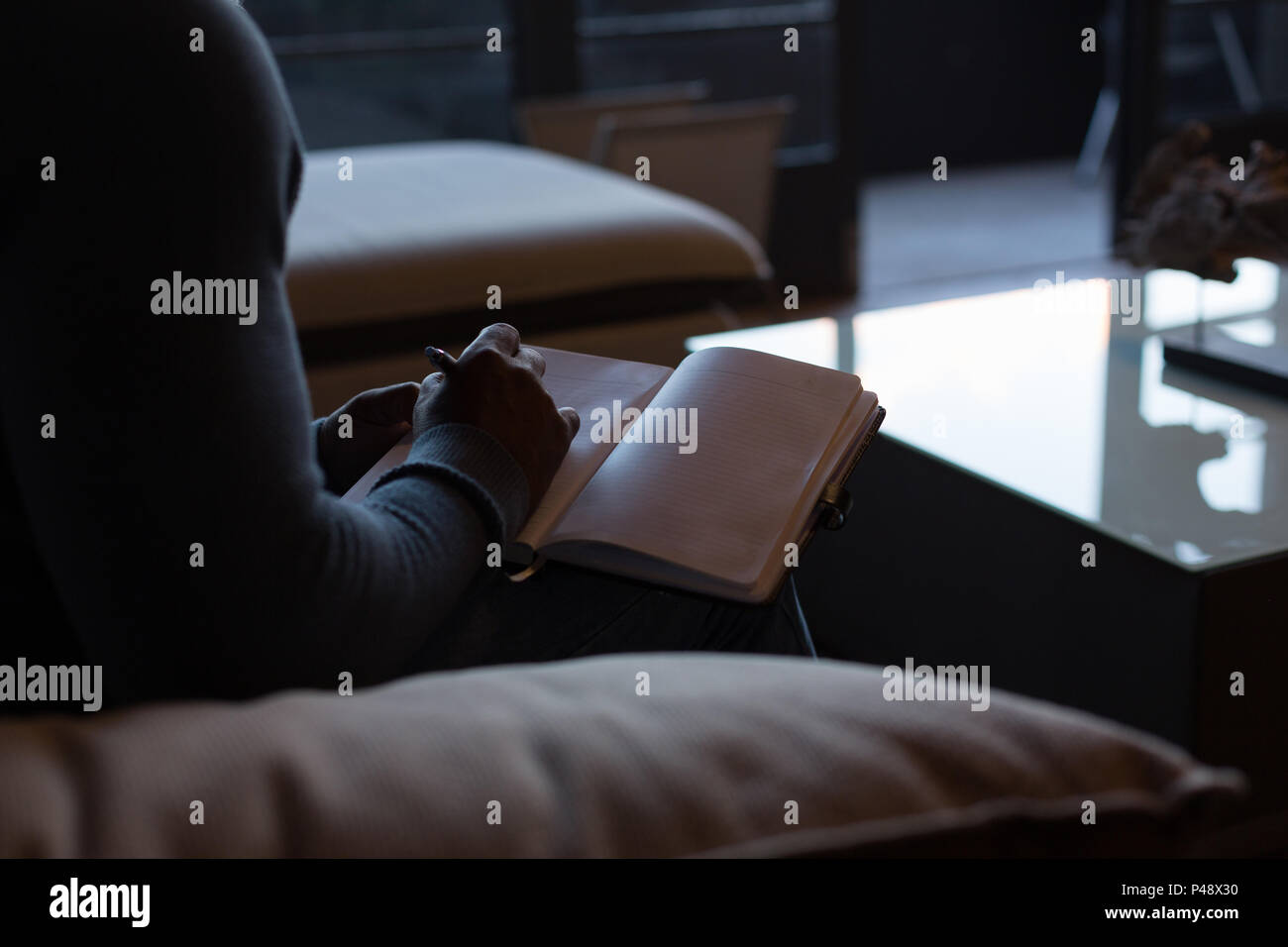 Senior man writing in a diary Stock Photo - Alamy