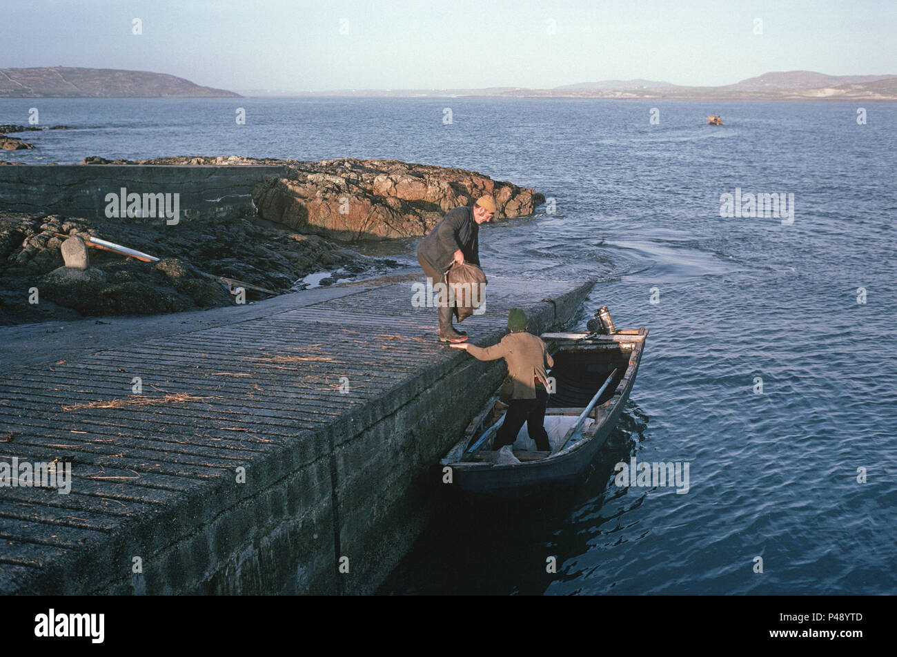 Inishturbot Islanders loading a curragh, traditional West coast of ...